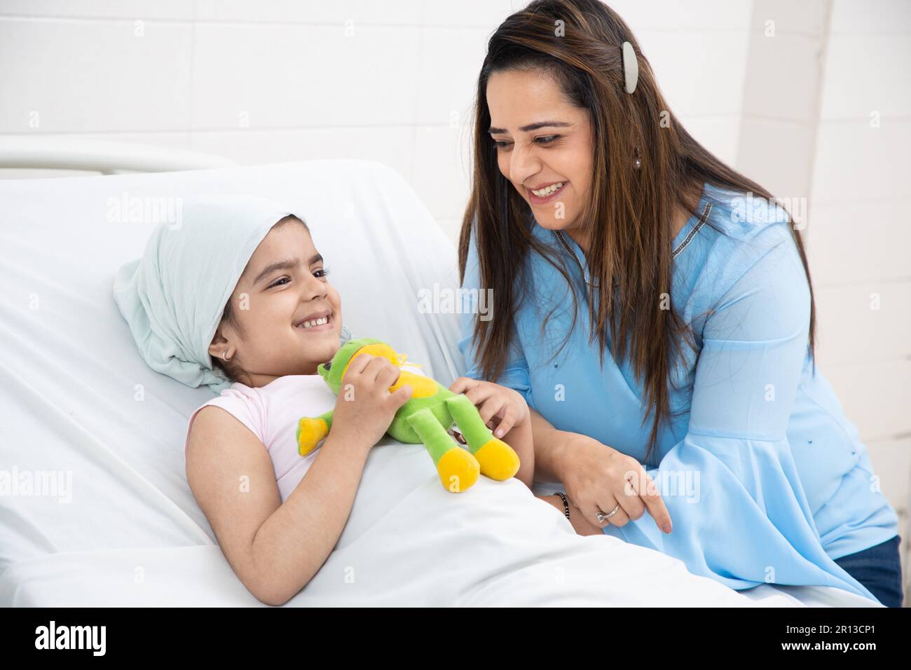 Indian woman playing with her little daughter cancer patient undergoing ...