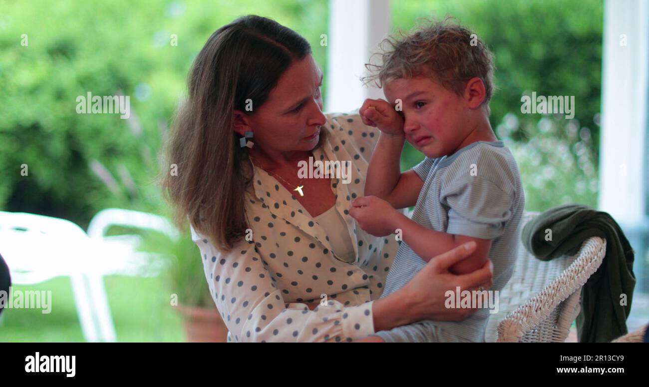 Mother consoling child boy. Candid authentic parent soothing and ...