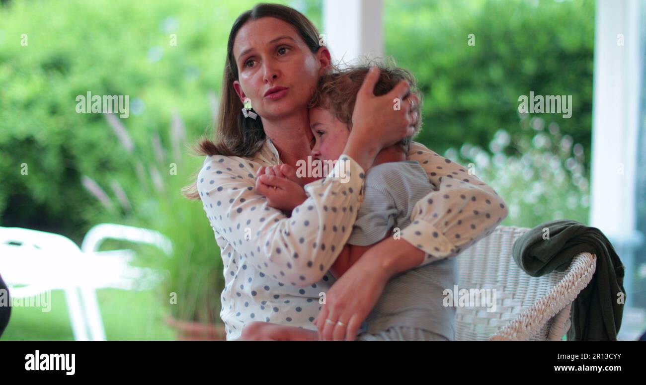 Mother consoling child boy. Candid authentic parent soothing and ...