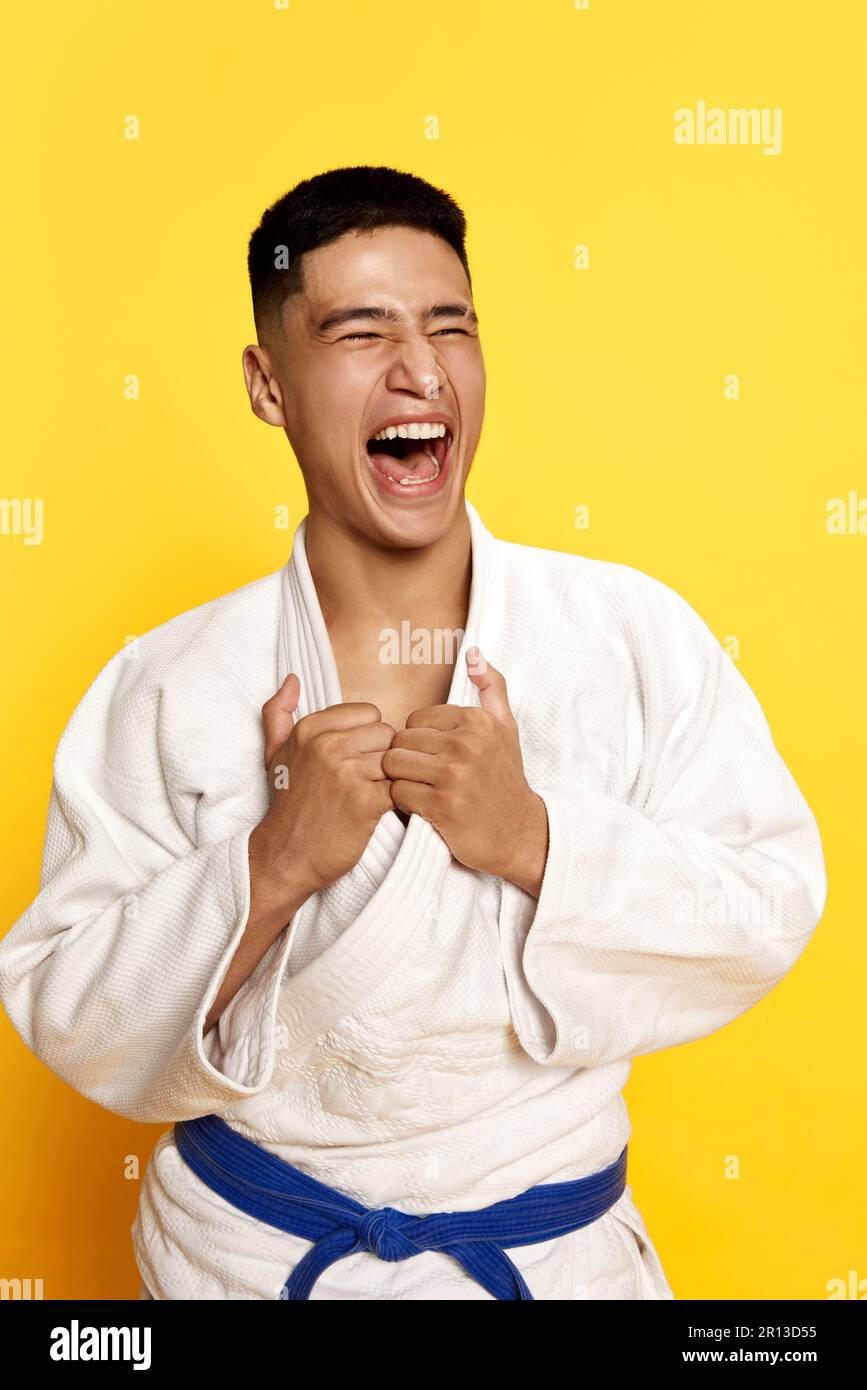Close up portrait with winner, male taekwondo, karate athlete wearing ...