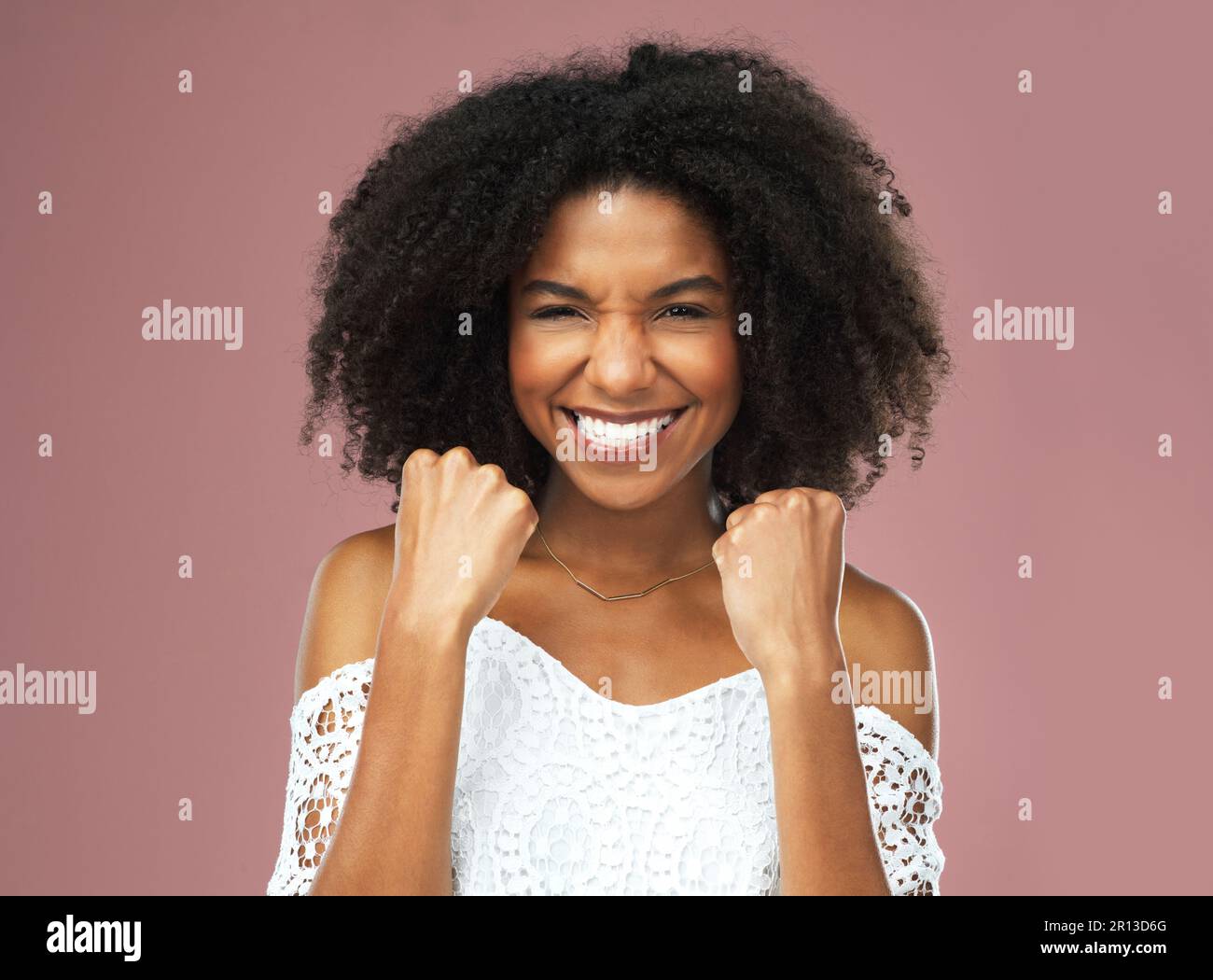 Theres no beating me now. a beautiful young woman cheering against a ...