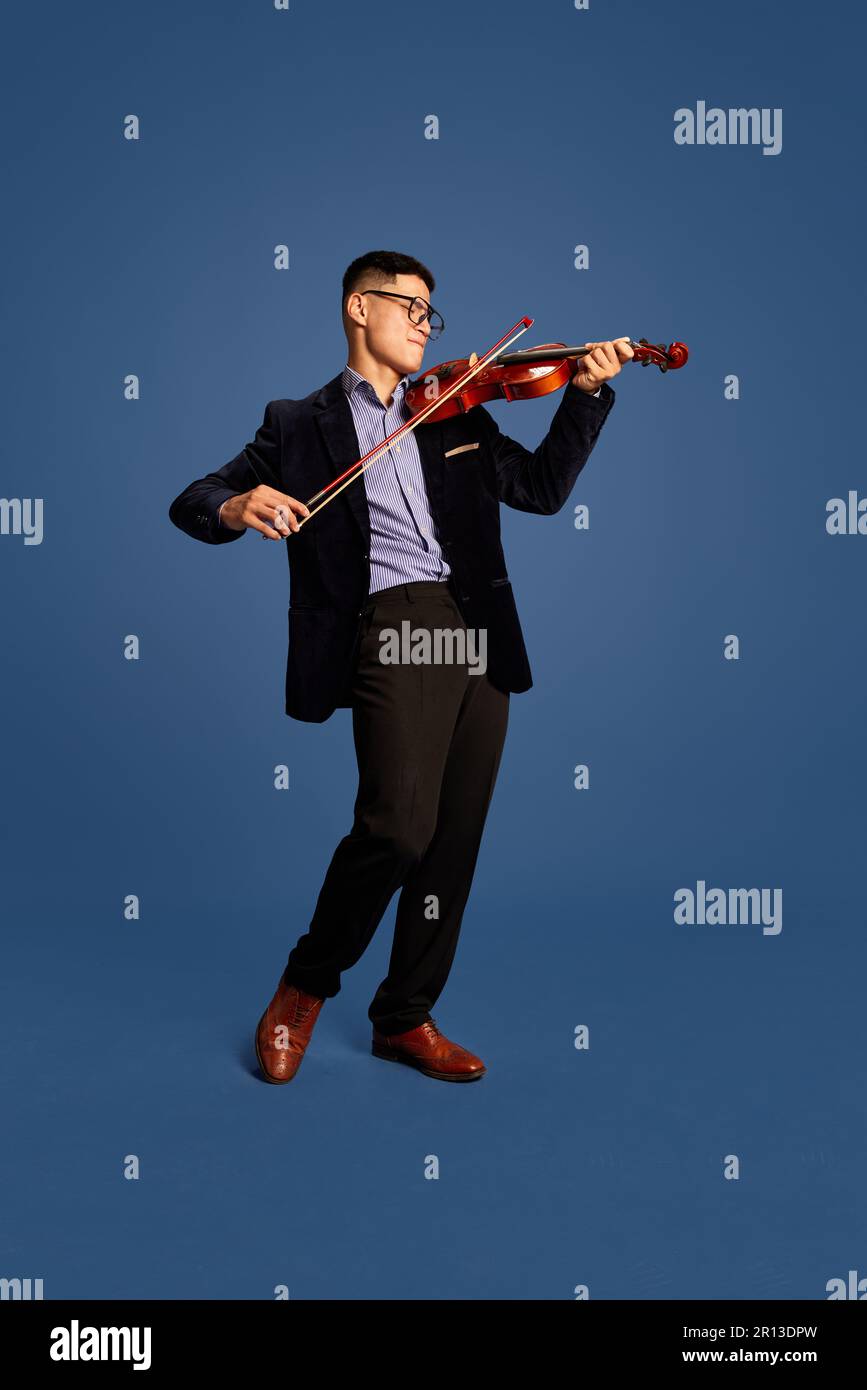 Portrait with professional, young musicians, violinist wearing ...
