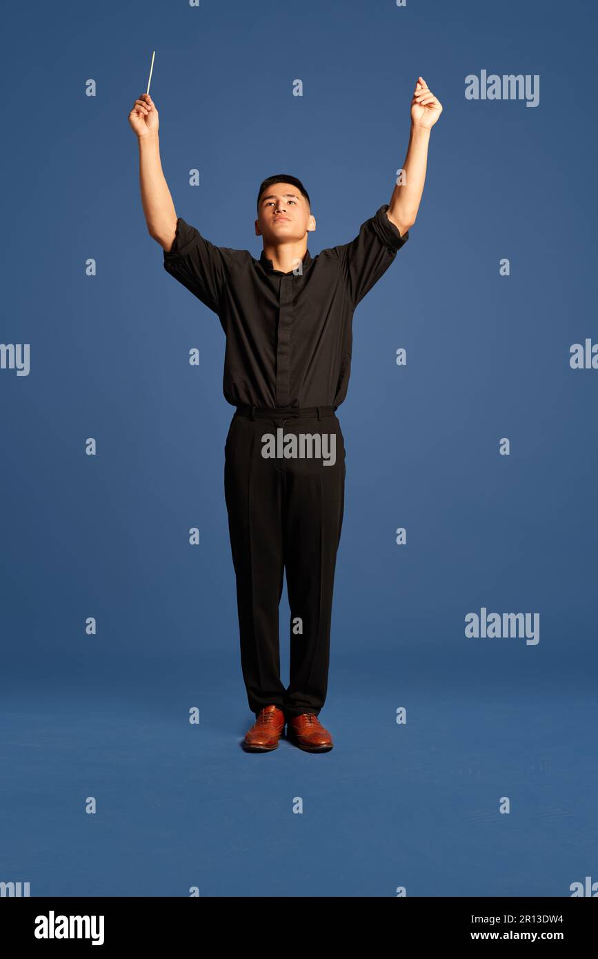 Portrait with one man, musician wearing costume holding conductor's ...