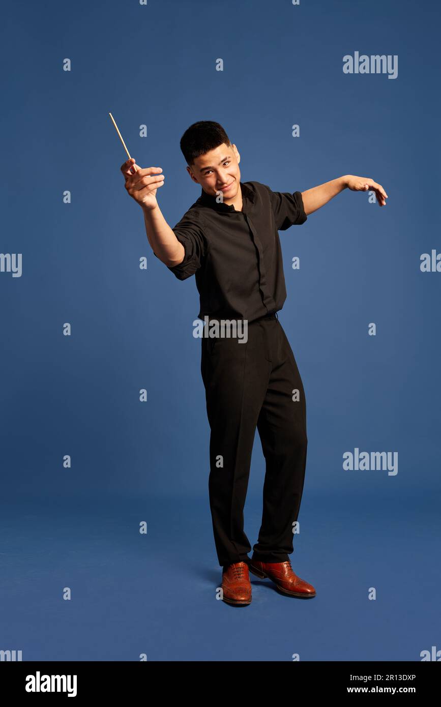 Portrait with one professional musician wearing elegant costume holding ...