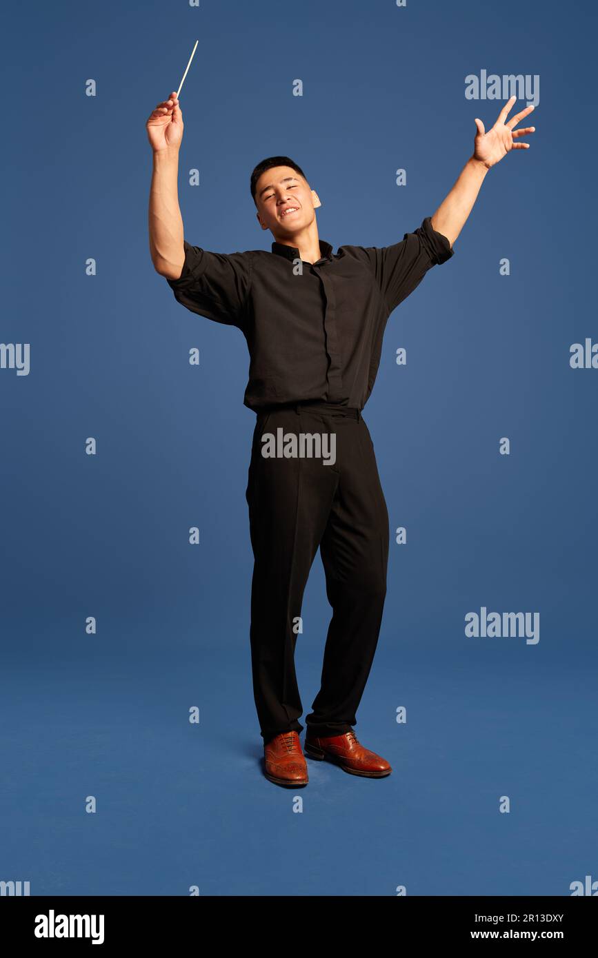 Portrait with one man, musician wearing costume holding conductor's ...