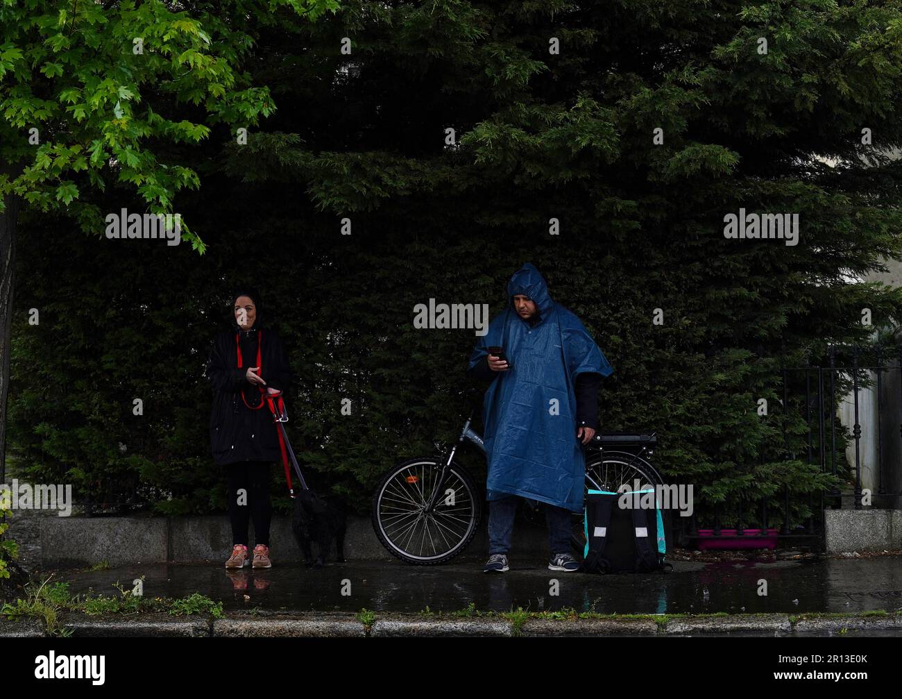 People seek shelter from a heavy rain shower on the southside of Dublin ...