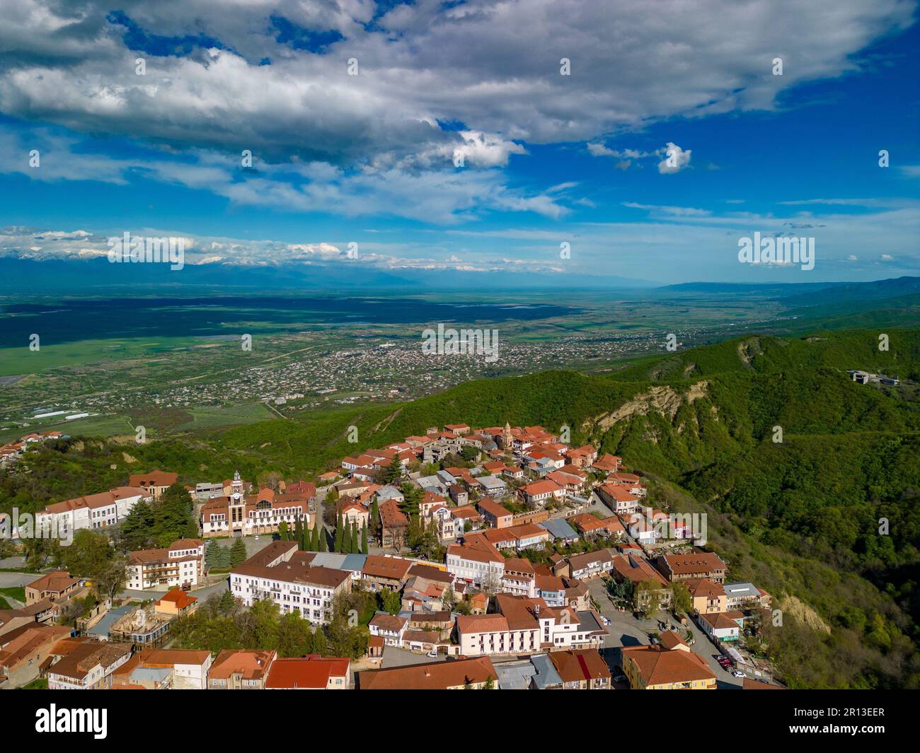 A scenic view of the blue sky with white clouds floating over the town ...