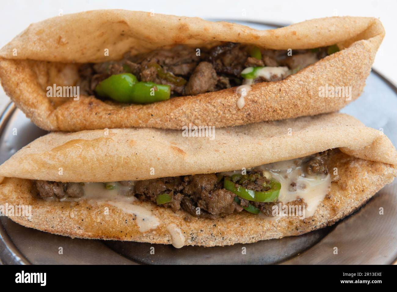 A plate of tasty fried liver and spicy green pepper sandwiches, one of ...