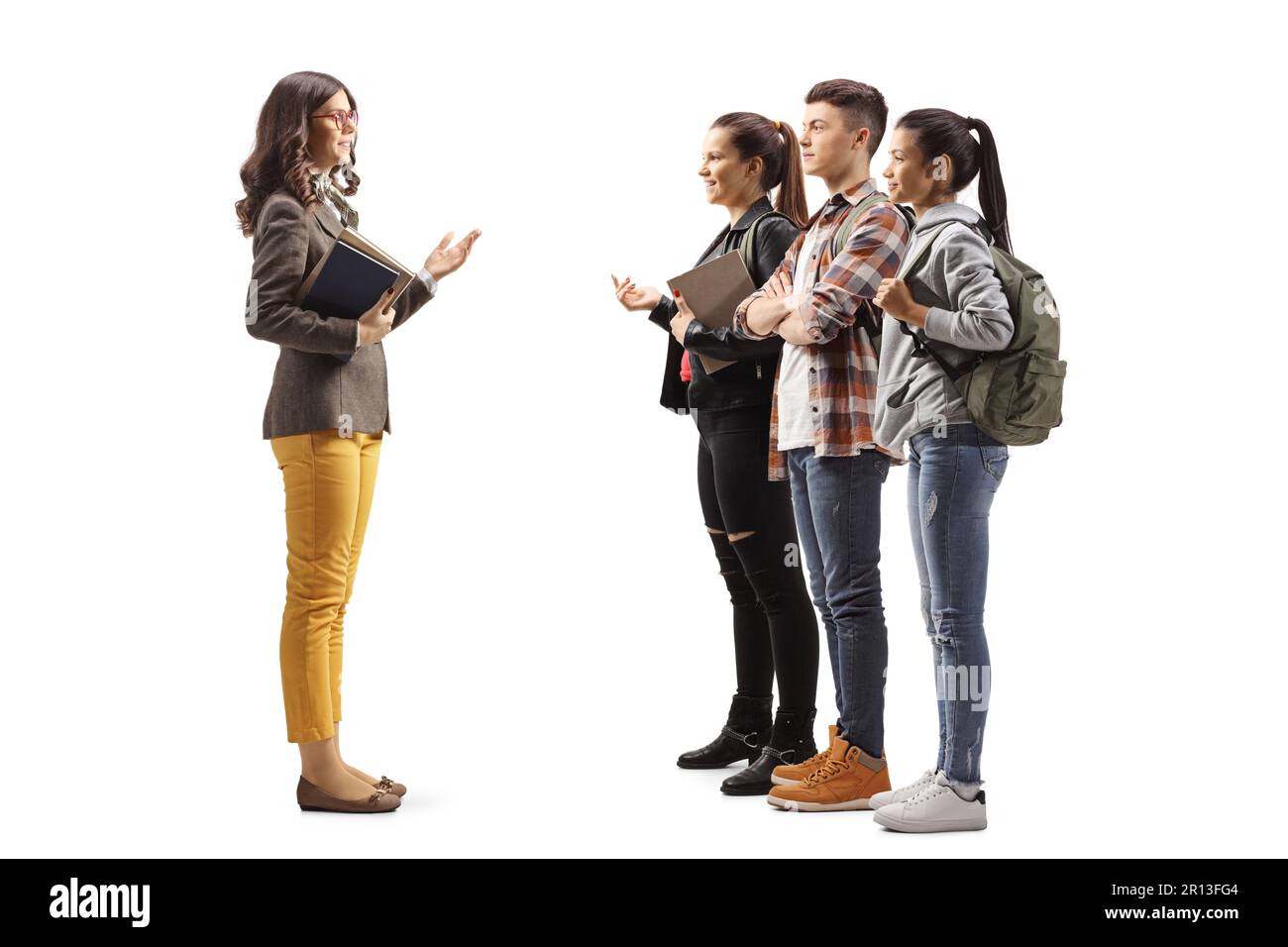 Full length profile shot of a young teacher talking to a group of ...