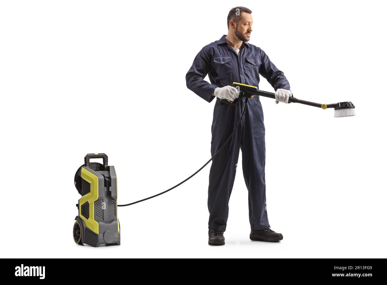 Full length shot of a worker using a pressure washer with a brush ...