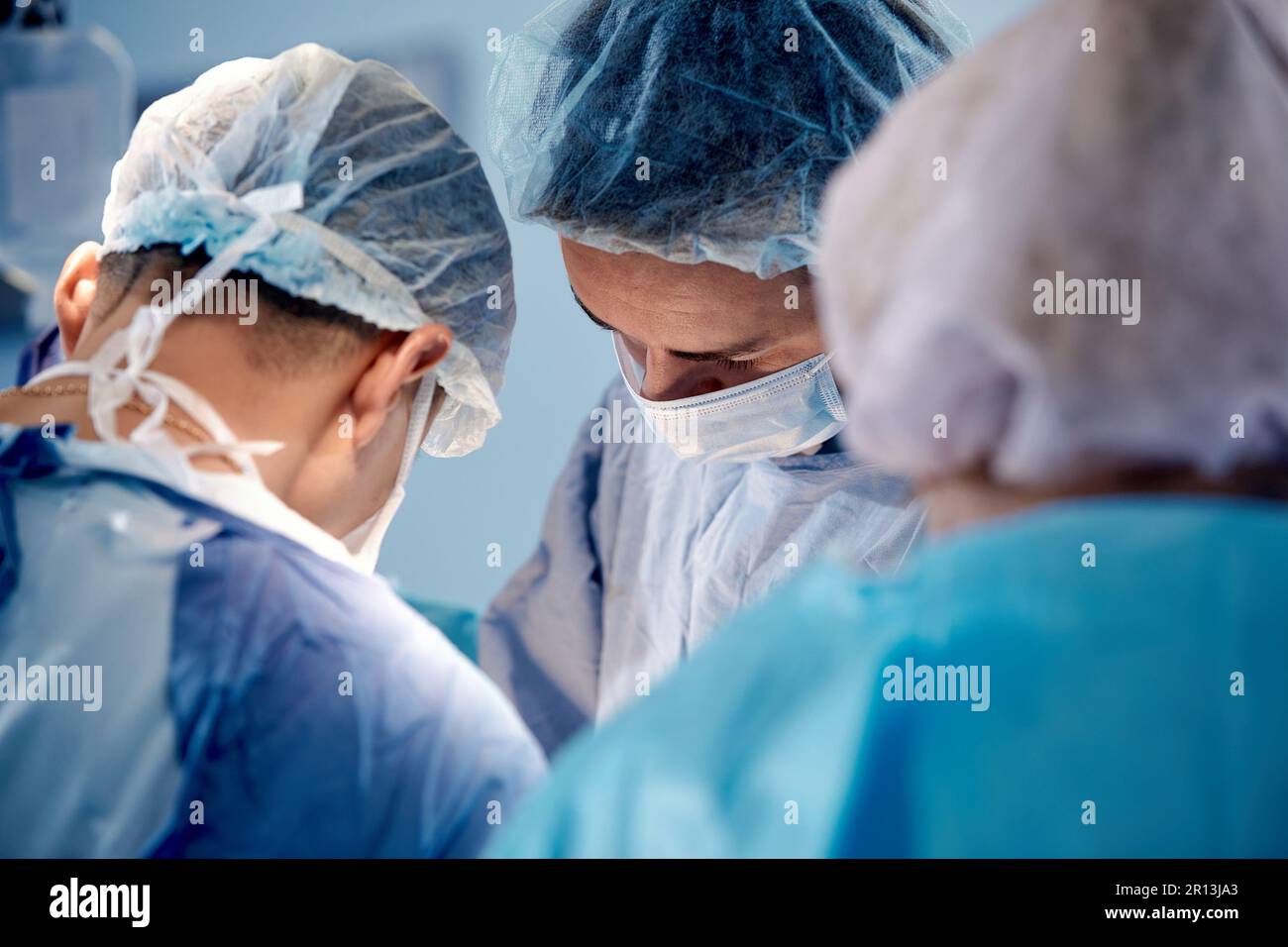 Faces of surgeons close-up during a complex and intense operation ...