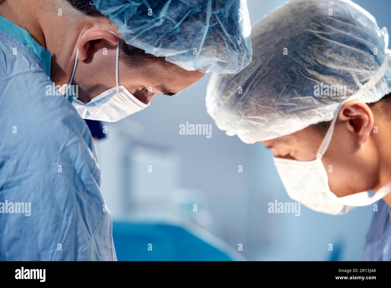 Faces of surgeons close-up during a complex and intense operation ...