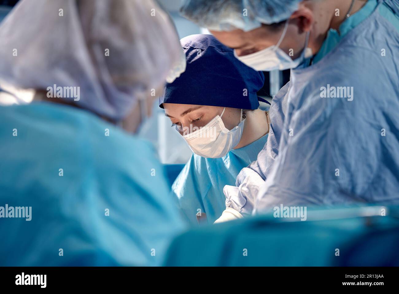 Faces of surgeons close-up during a complex and intense operation ...