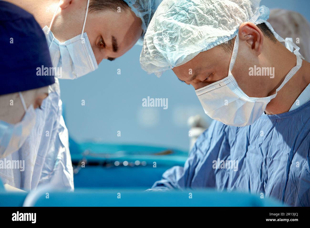 Faces of surgeons close-up during a complex and intense operation ...