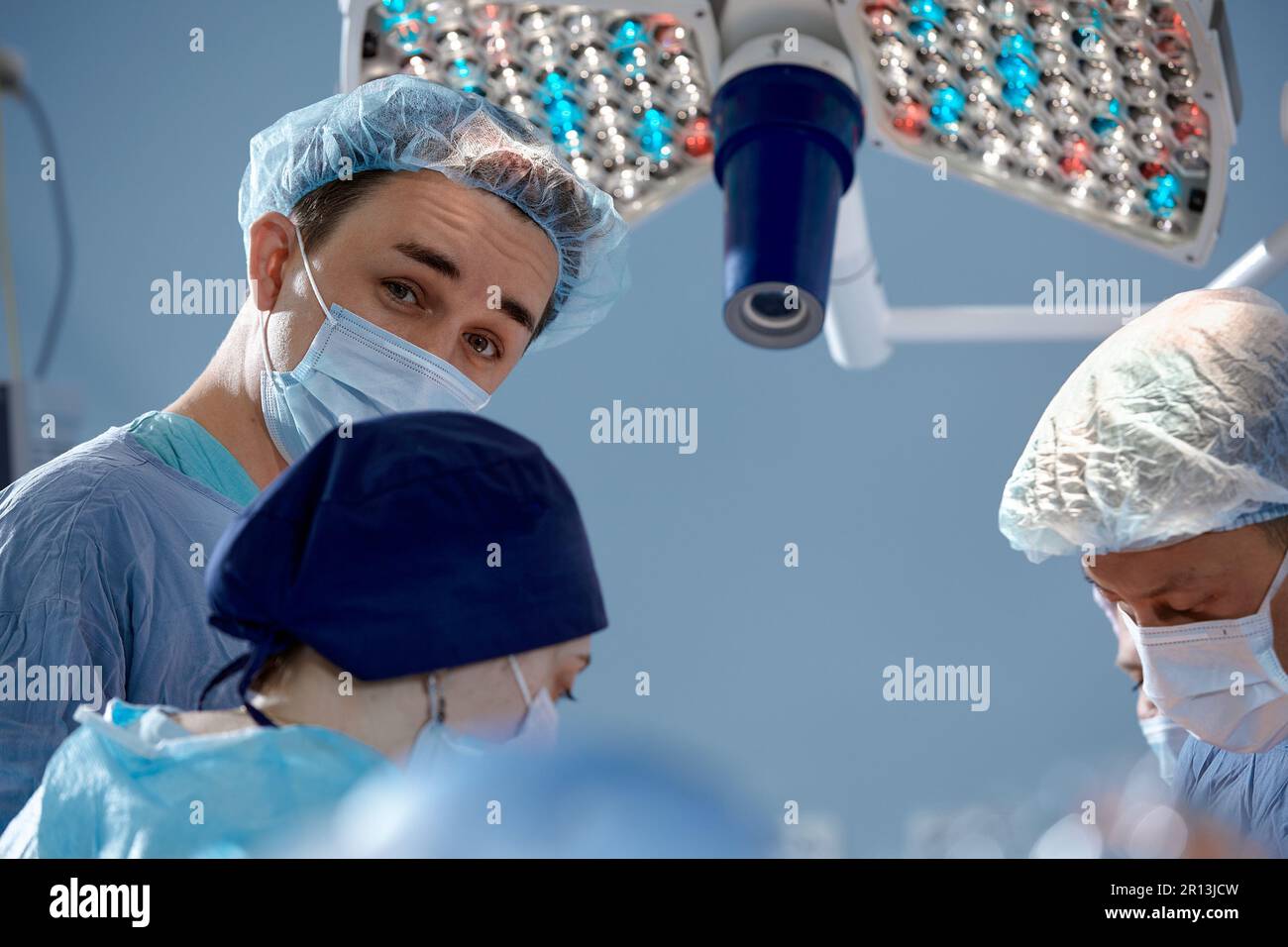 Group of surgeons doing surgery in hospital operating theater ...