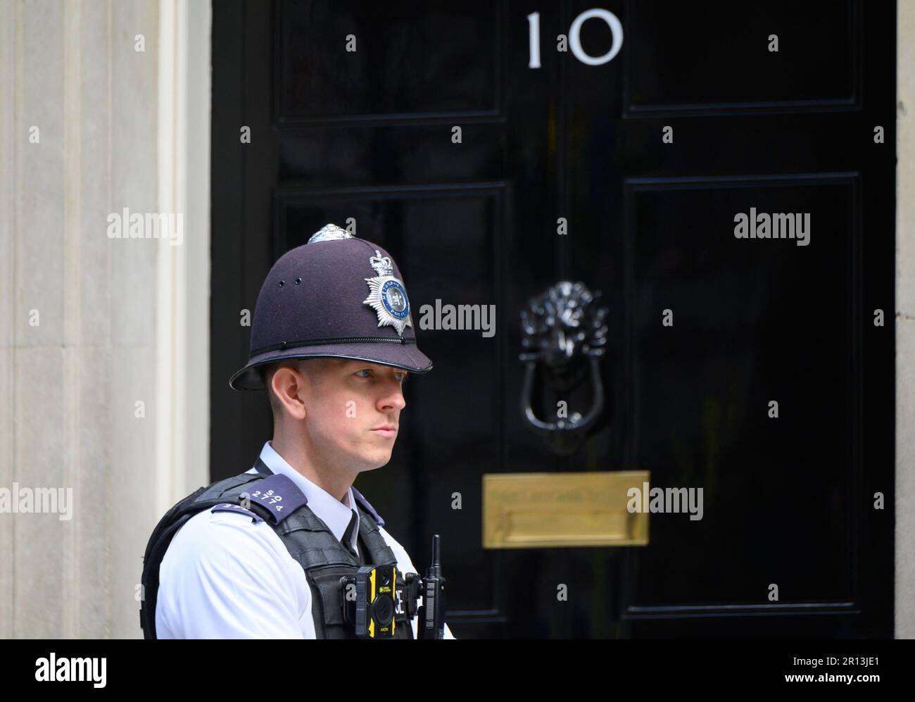 London, England, UK. Police officer passing the door of 10 Dowing ...