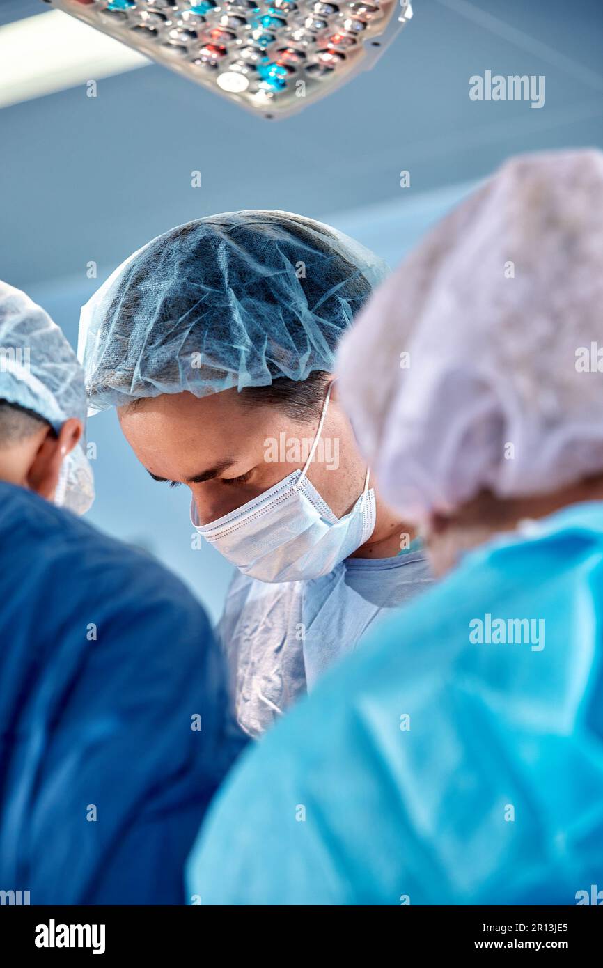 Faces of surgeons close-up during a complex and intense operation ...