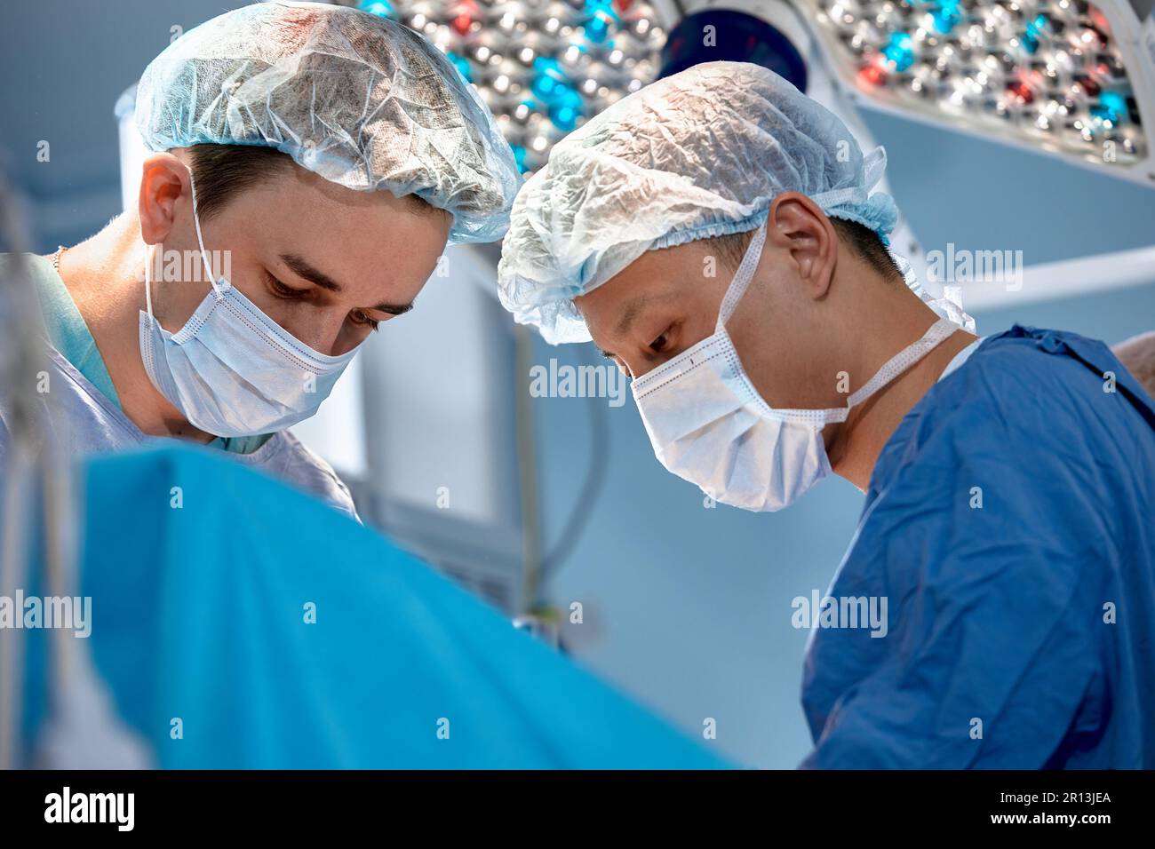 Faces of surgeons close-up during a complex and intense operation ...