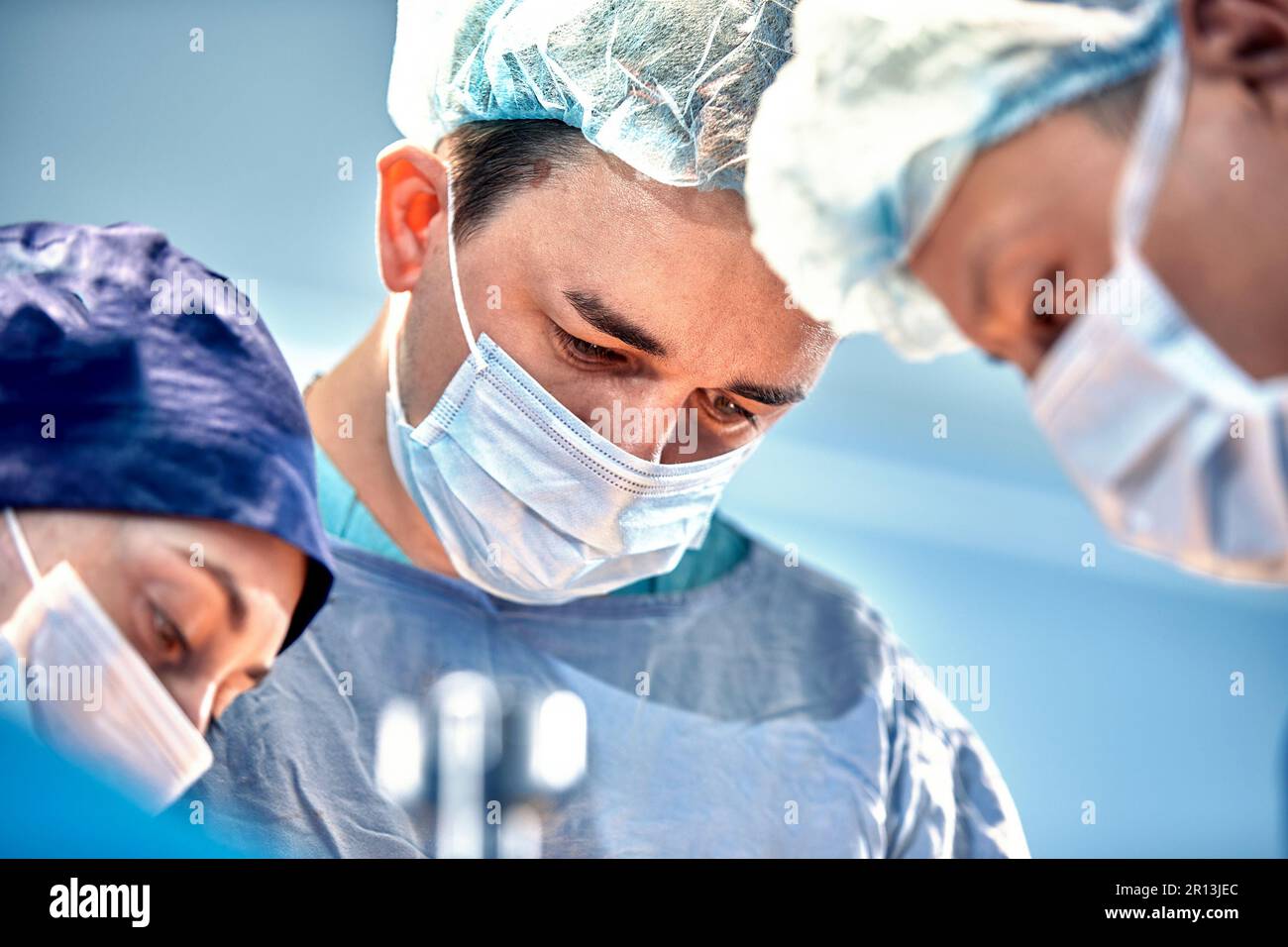 Faces of surgeons close-up during a complex and intense operation ...