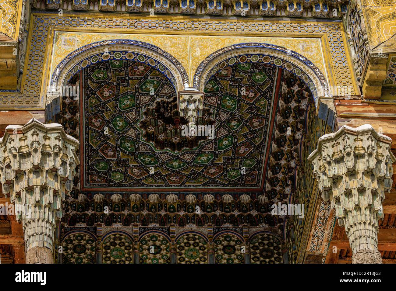 detail of the intricately carved colourful wooden roof of the iwan of ...