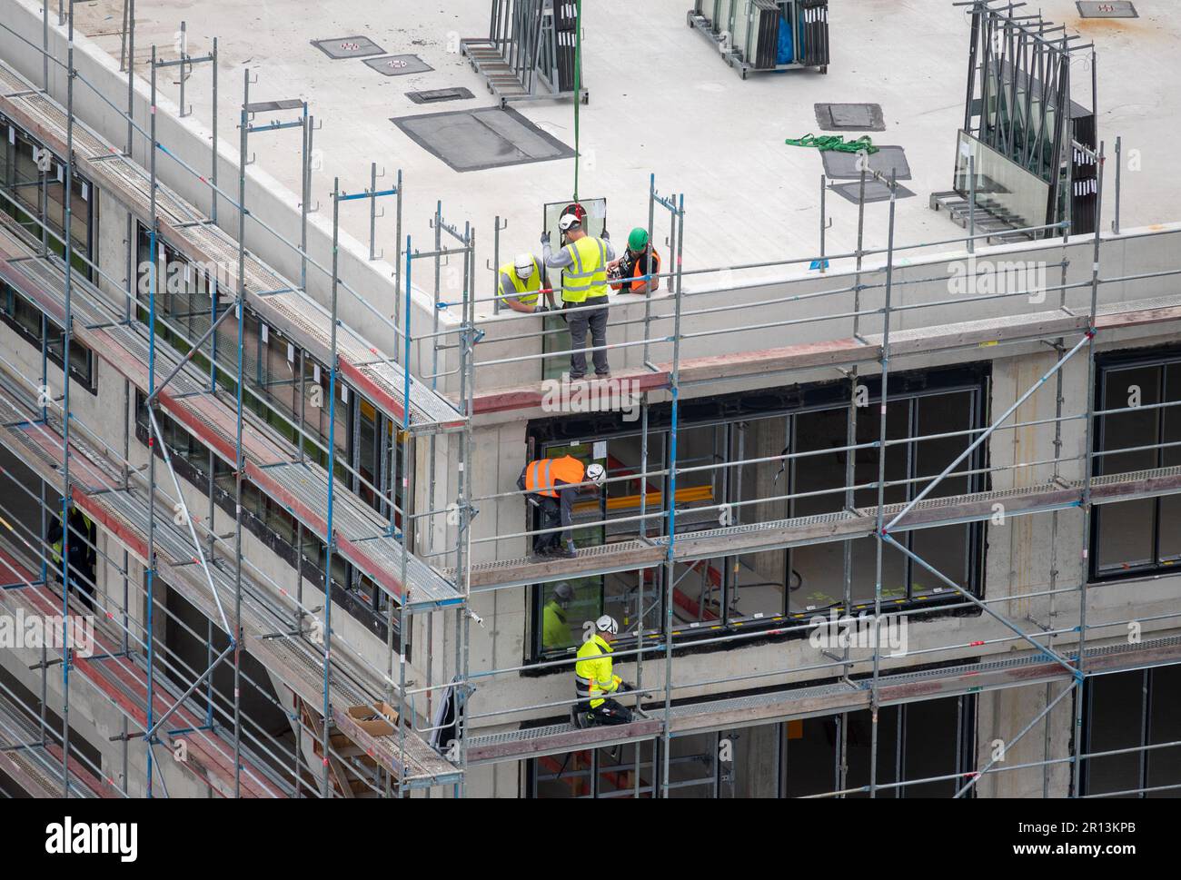 Glazier installing windows on a commercial building Stock Photo - Alamy