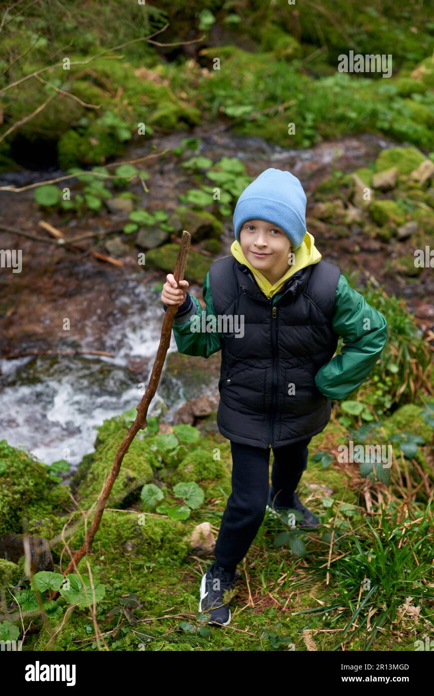 Children hiking in Alps mountains crossing river. Kids play in water at ...