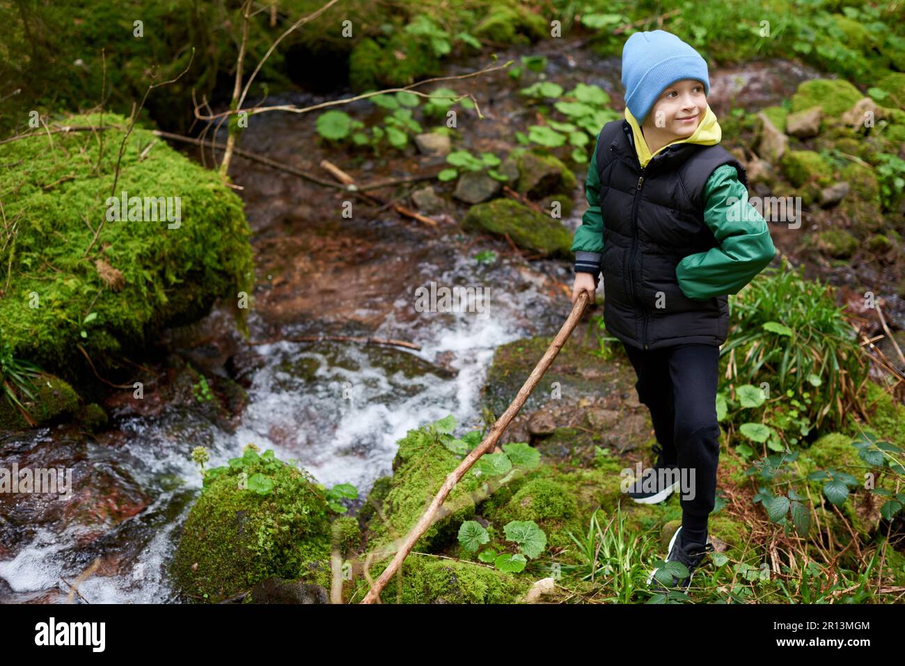 Children hiking in Alps mountains crossing river. Kids play in water at ...