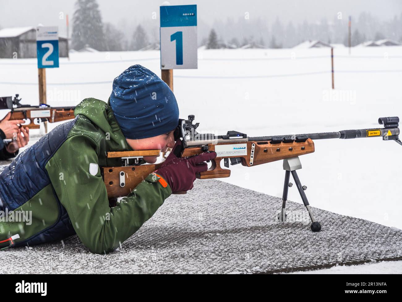 Boy doing shooting practice with a laser rifle for biathlon training in ...