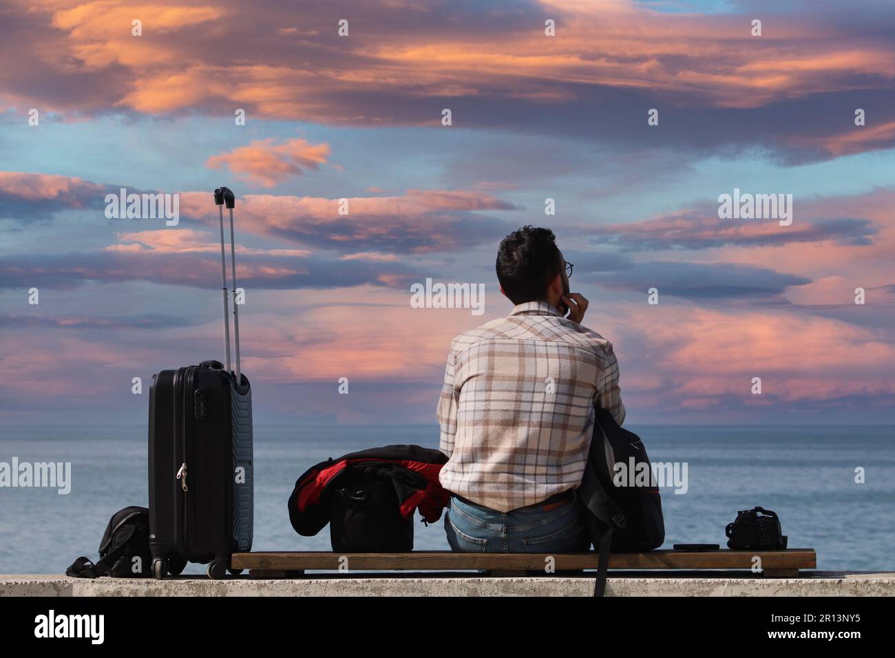man sitting on bench with suitcase. Sad man feeling lonely, sitting on ...