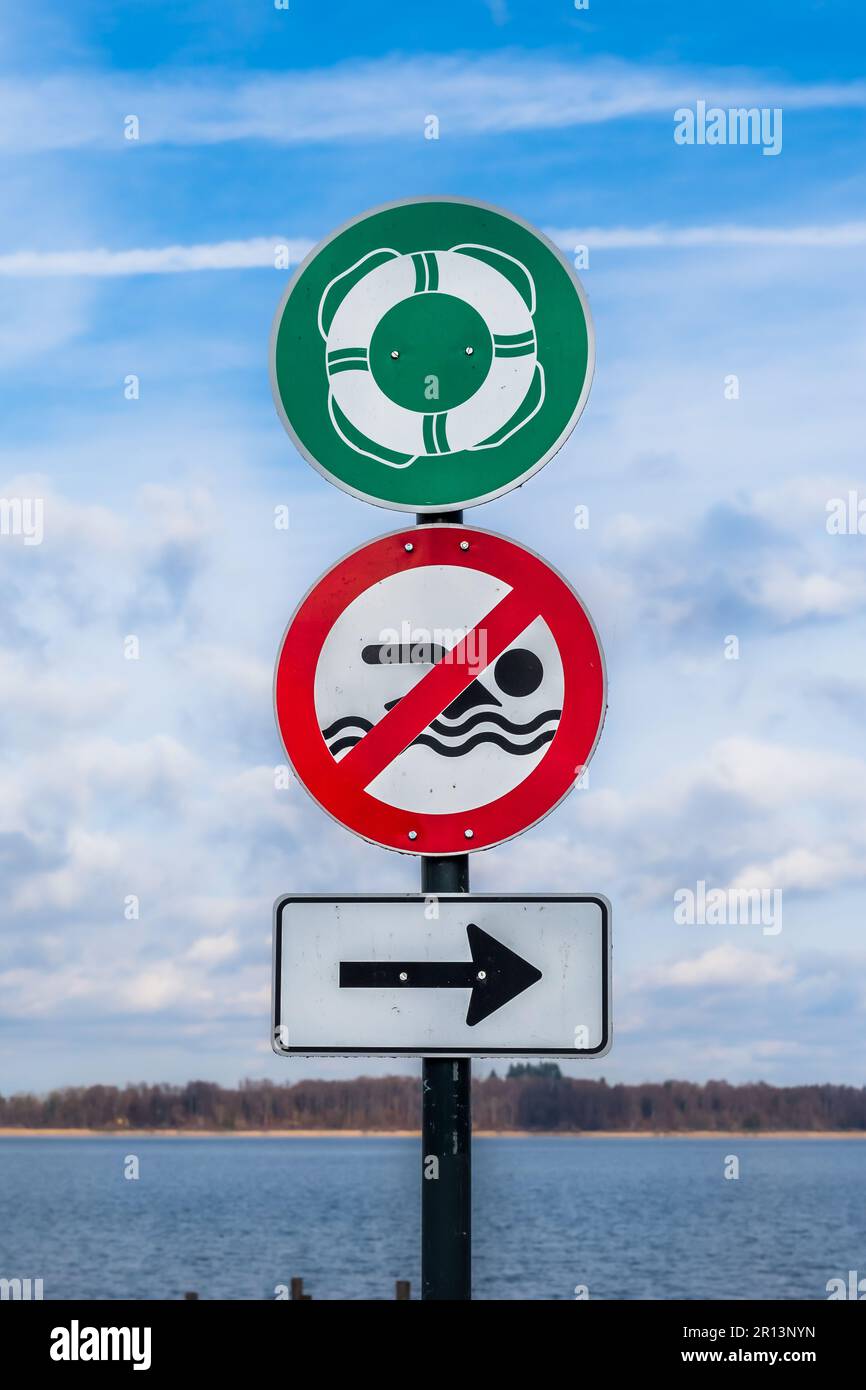 Warning and information signs for bathers on the shore of a lake Stock ...