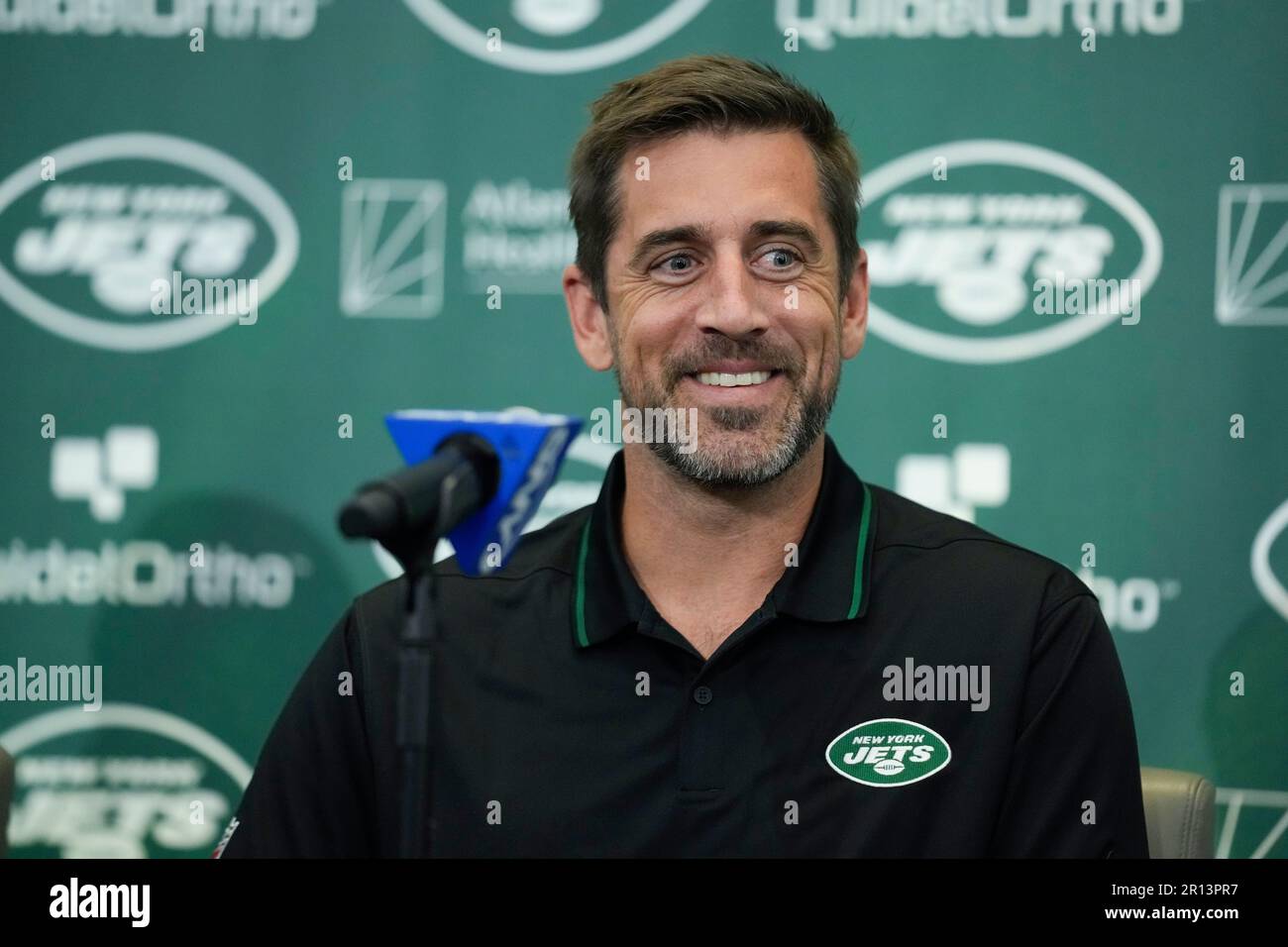 FILE - New York Jets' quarterback Aaron Rodgers smiles during an NFL ...