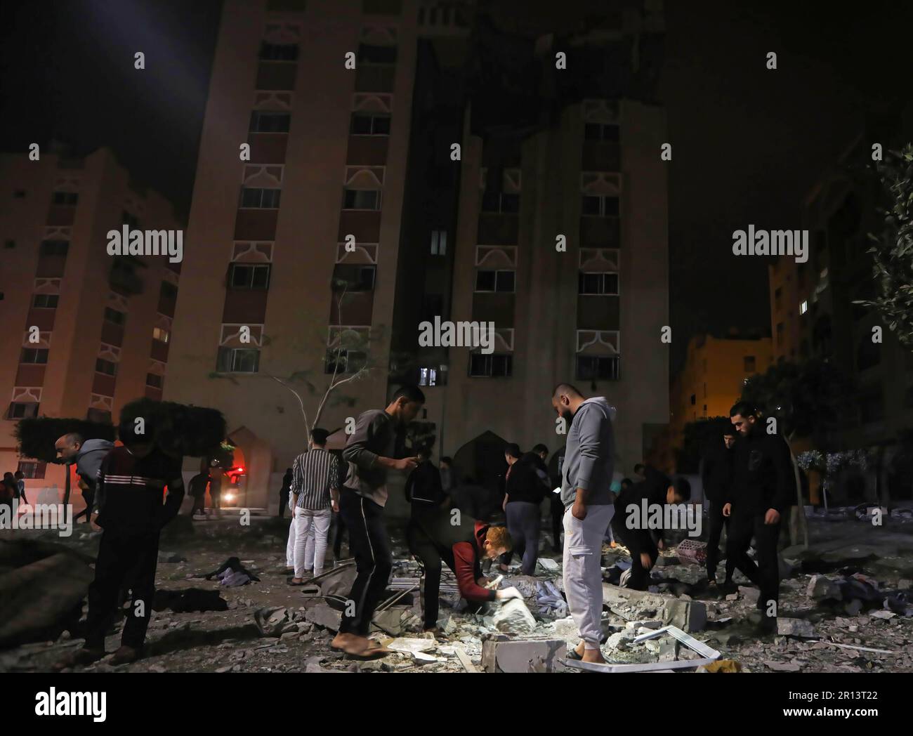 Palestinians inspect the ruins of the house of the prominent leader of ...
