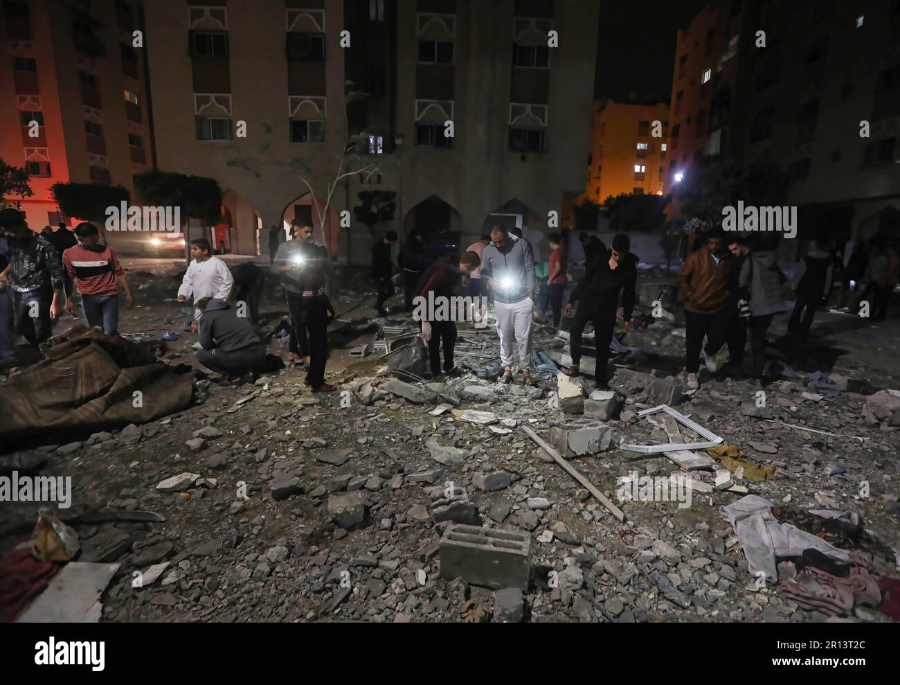 Palestinians inspect the ruins of the house of the prominent leader of ...