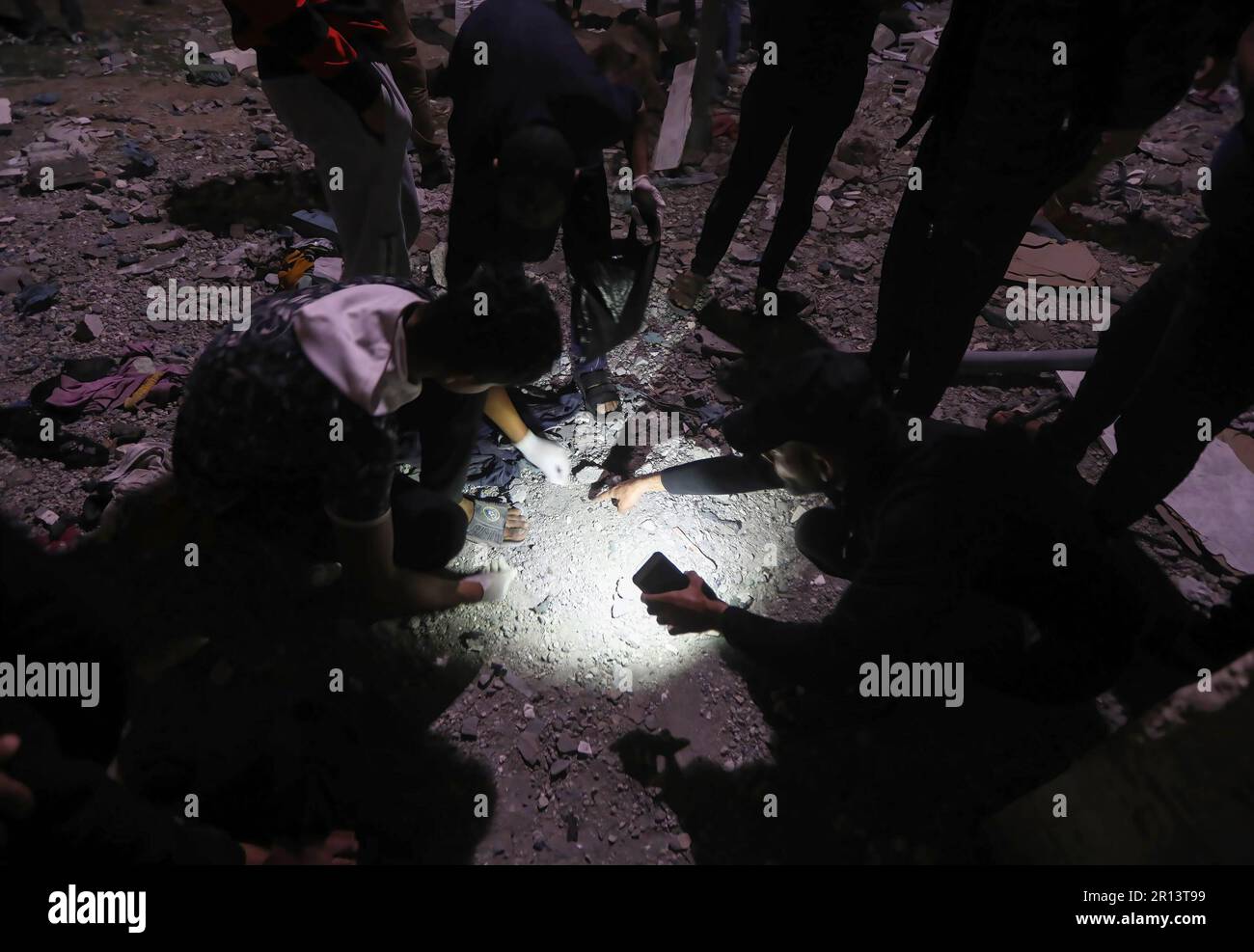 Gaza, Palestine. 11th May, 2023. Palestinians inspect the ruins of the ...