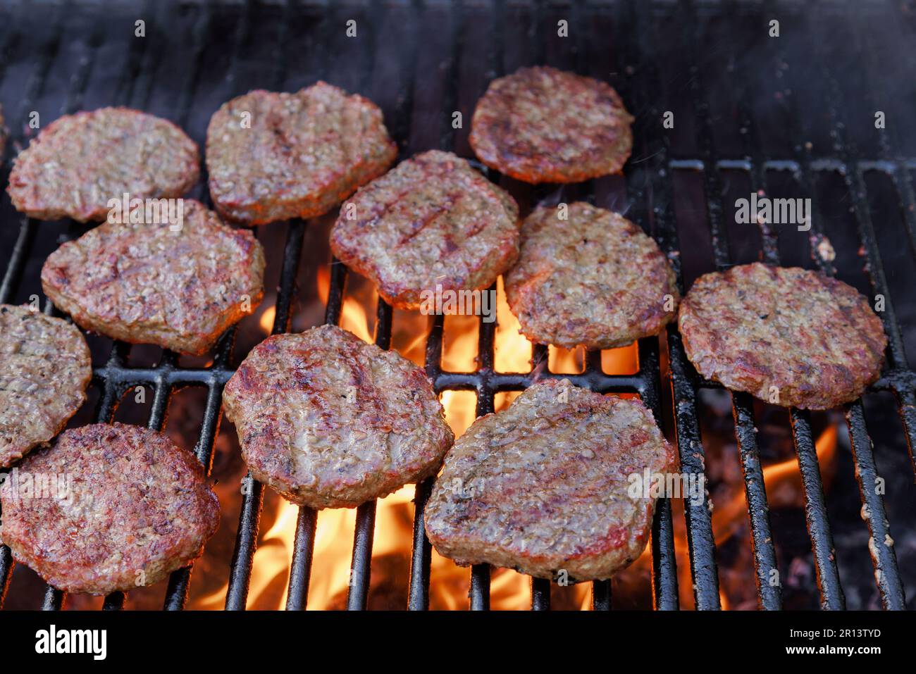Grilled American beef burger barbecued on hot grill over flame Stock ...
