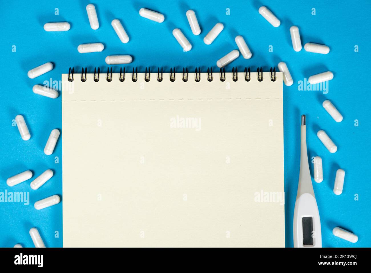 Medical notepad with pills on a blue background, space for text Stock ...