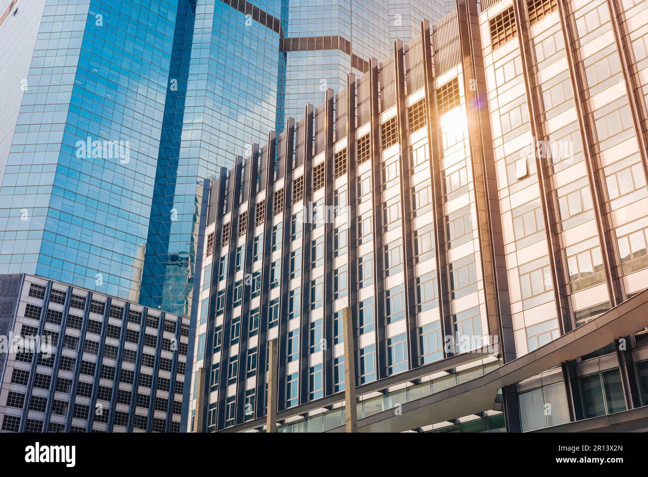 Morning sunlight reflecting on shiny windows of blue modern building in ...