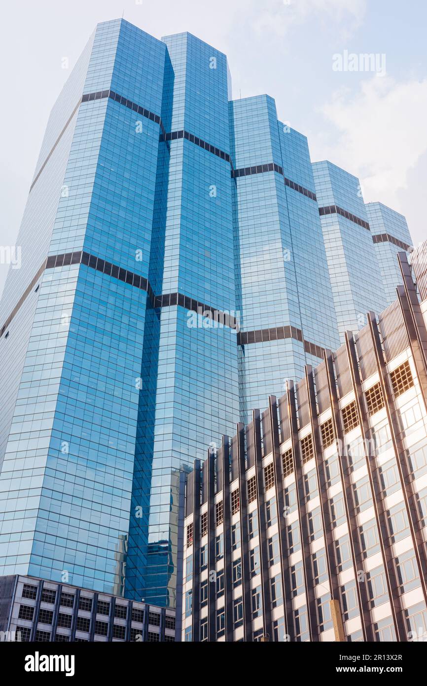 Morning sunlight reflecting on shiny windows of blue modern building in ...
