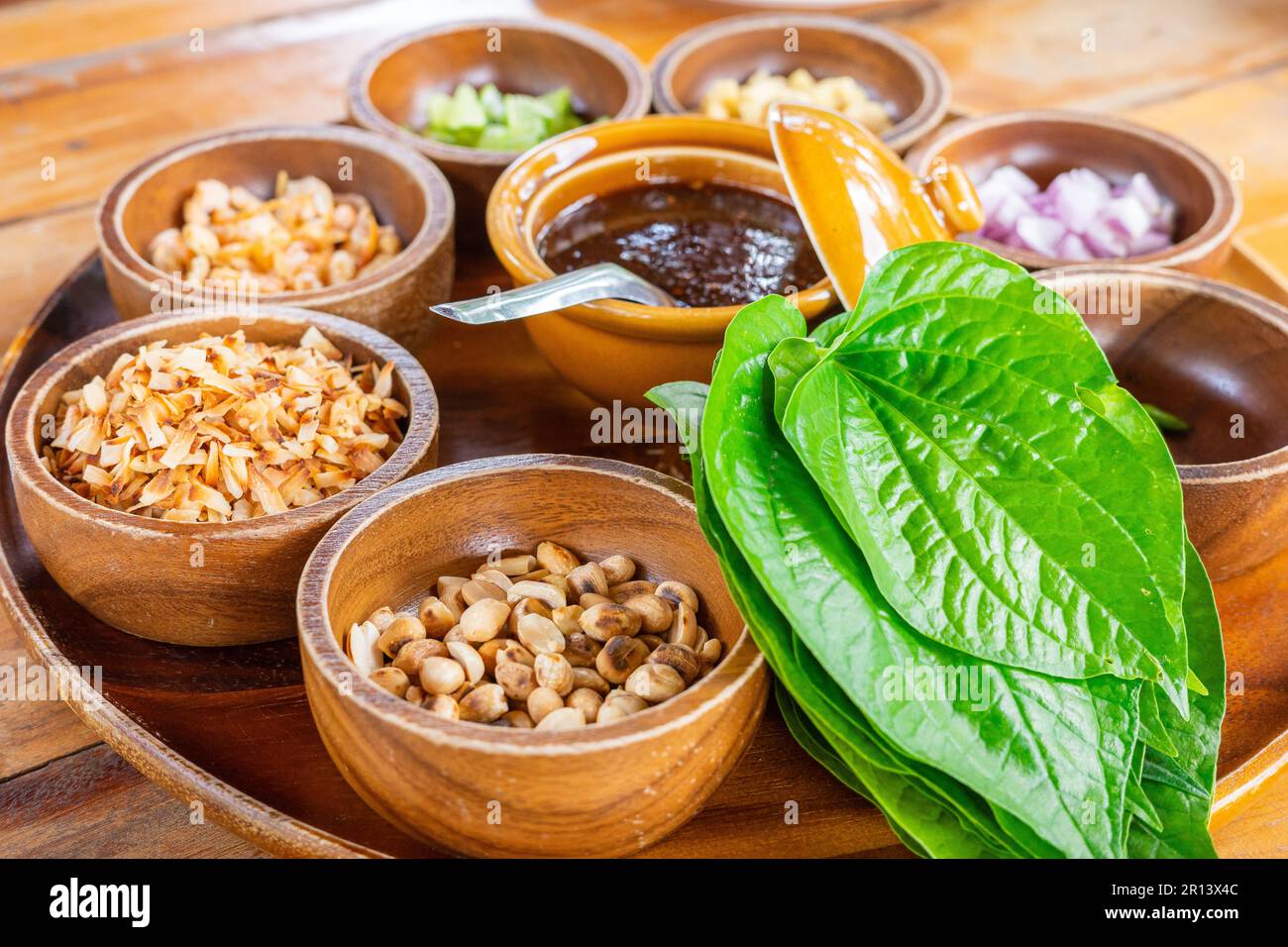 Big dish of plenty in fresh ingredients with green betel leaves called ...