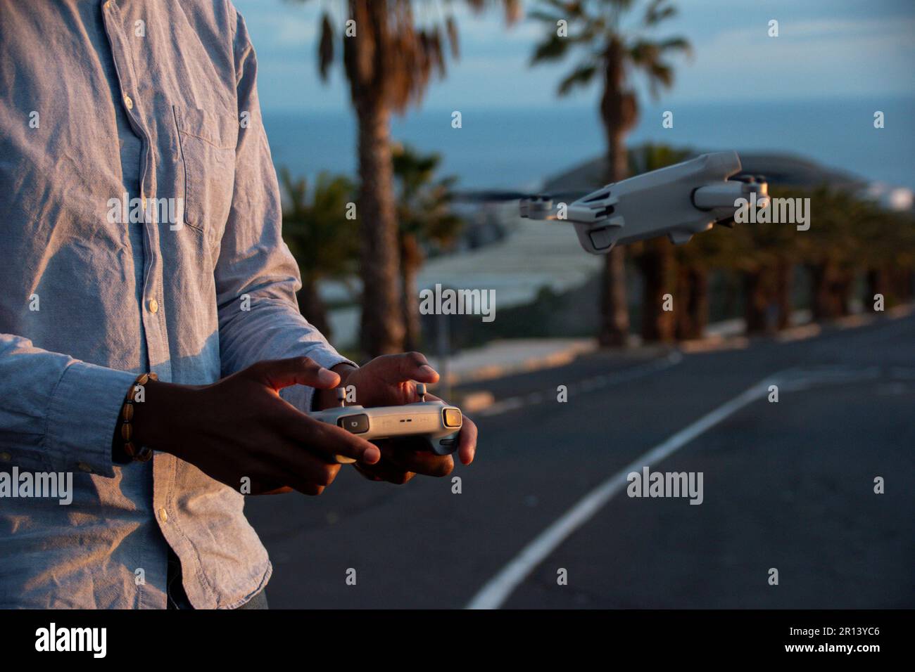 Close-up of an African American man's hands controlling his drone ...