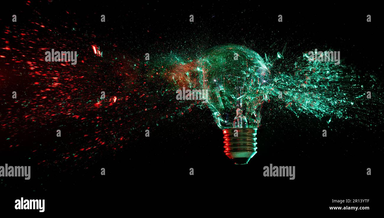 light bulb shattering on black background Stock Photo - Alamy