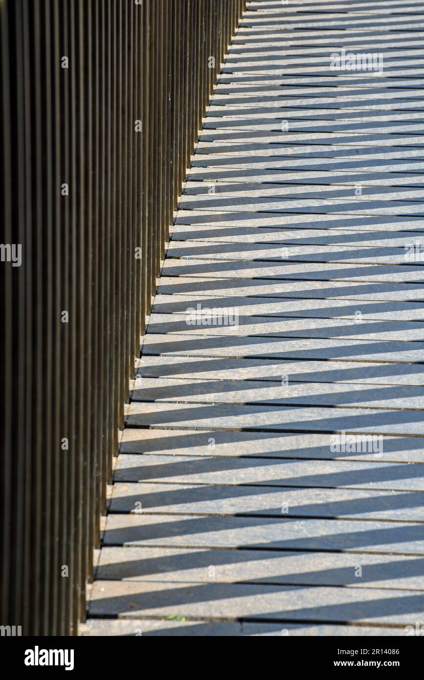 An abstract pattern cast by shadows from a fence onto a pathway Stock ...