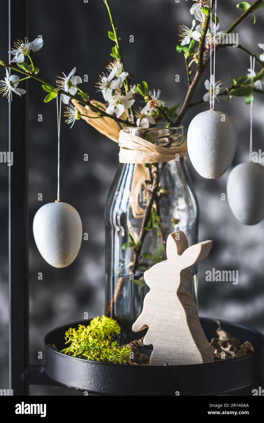 Easter decoration with white cherry blossom branches and white eggs in ...