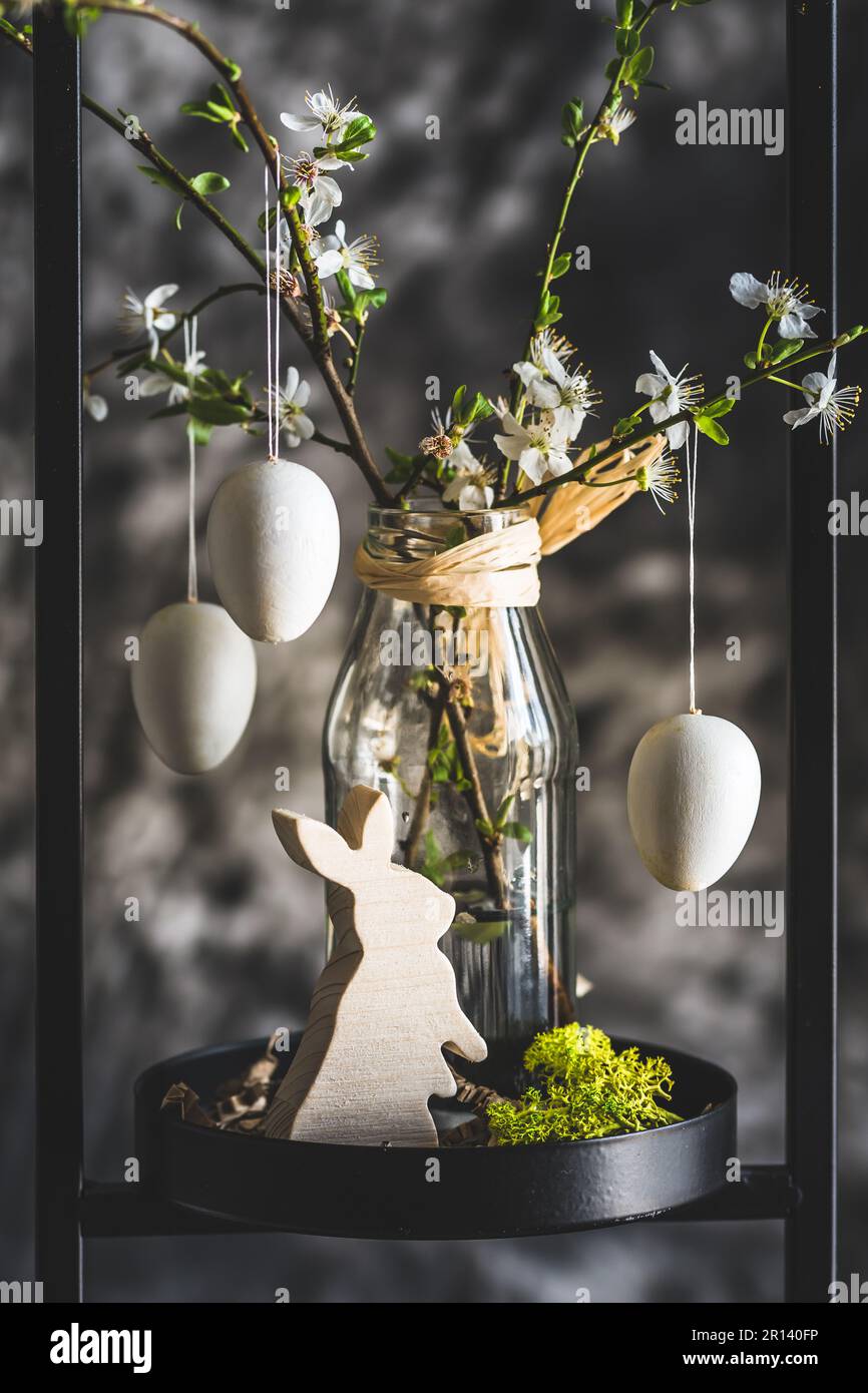 Easter decoration with white cherry blossom branches and white eggs in ...