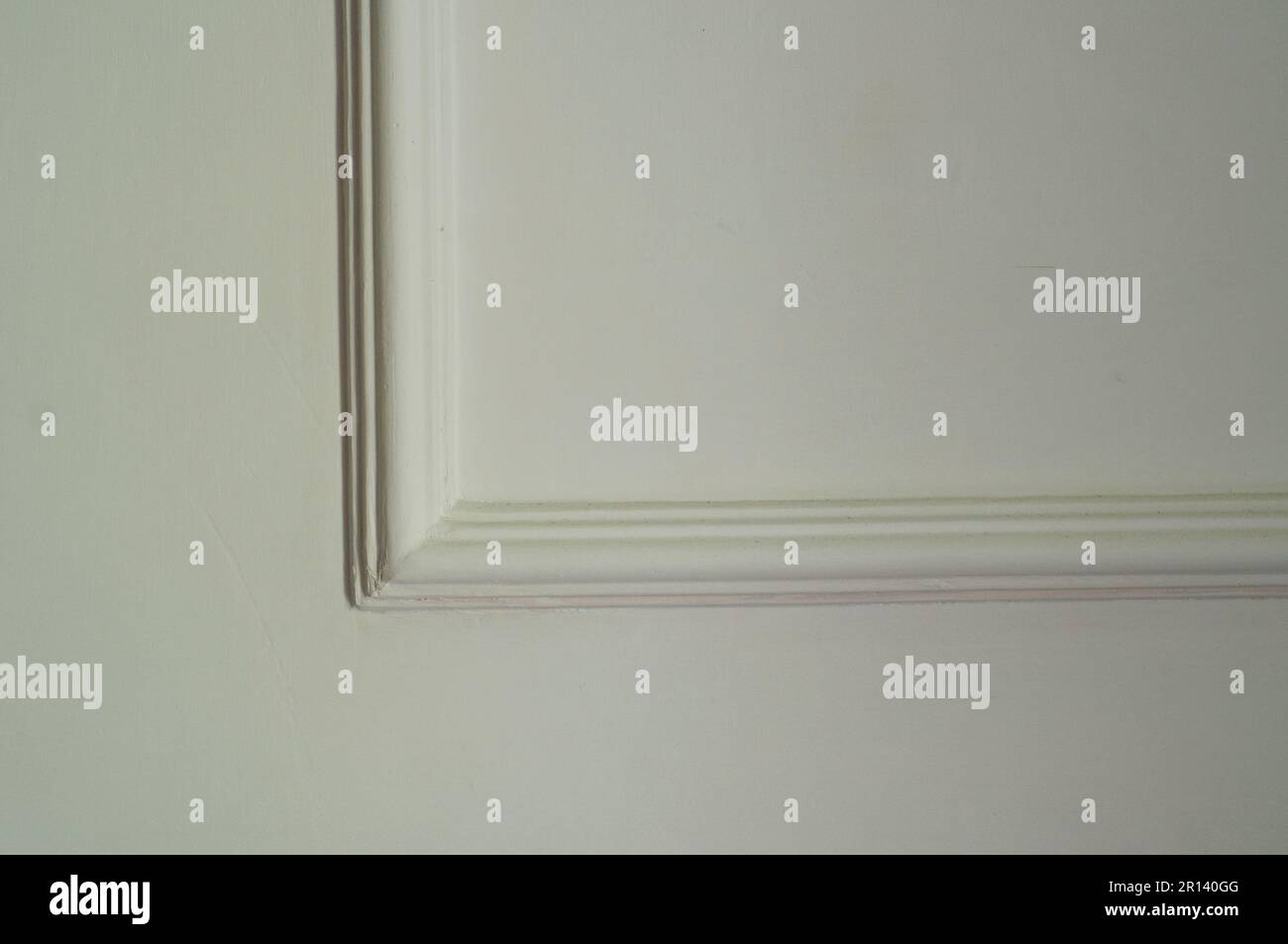A close up shot of a white wooden moulding on a plain white wall Stock ...