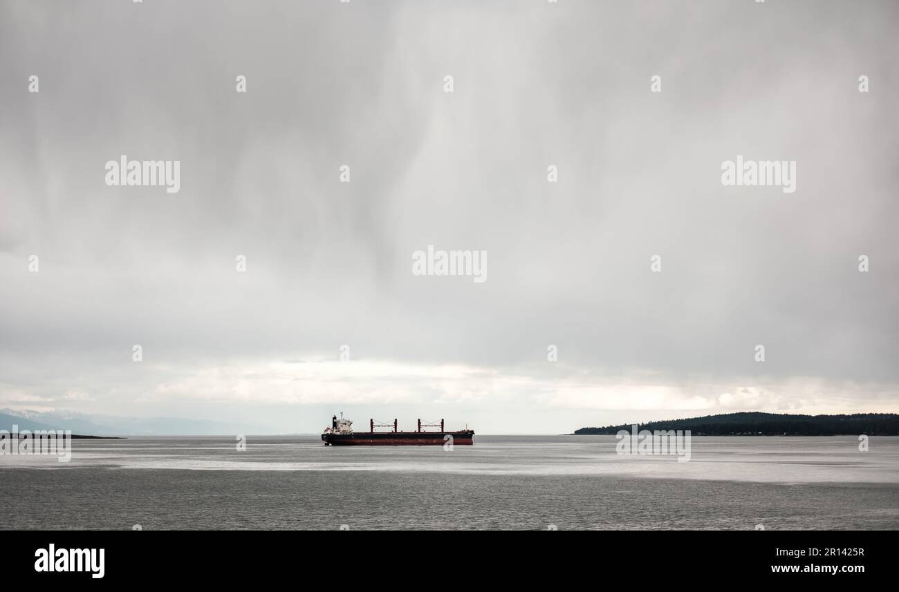 An ocean going cargo ship sits at its mooring outside of Nanaimo BC to ...