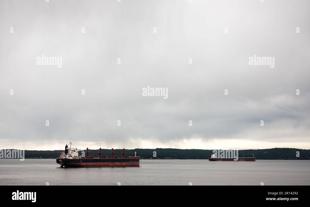 An ocean going cargo ship sits at its mooring outside of Nanaimo BC to ...