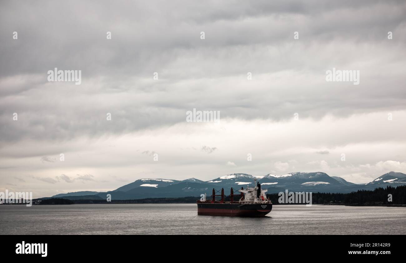 An ocean going cargo ship sits at its mooring outside of Nanaimo BC to ...