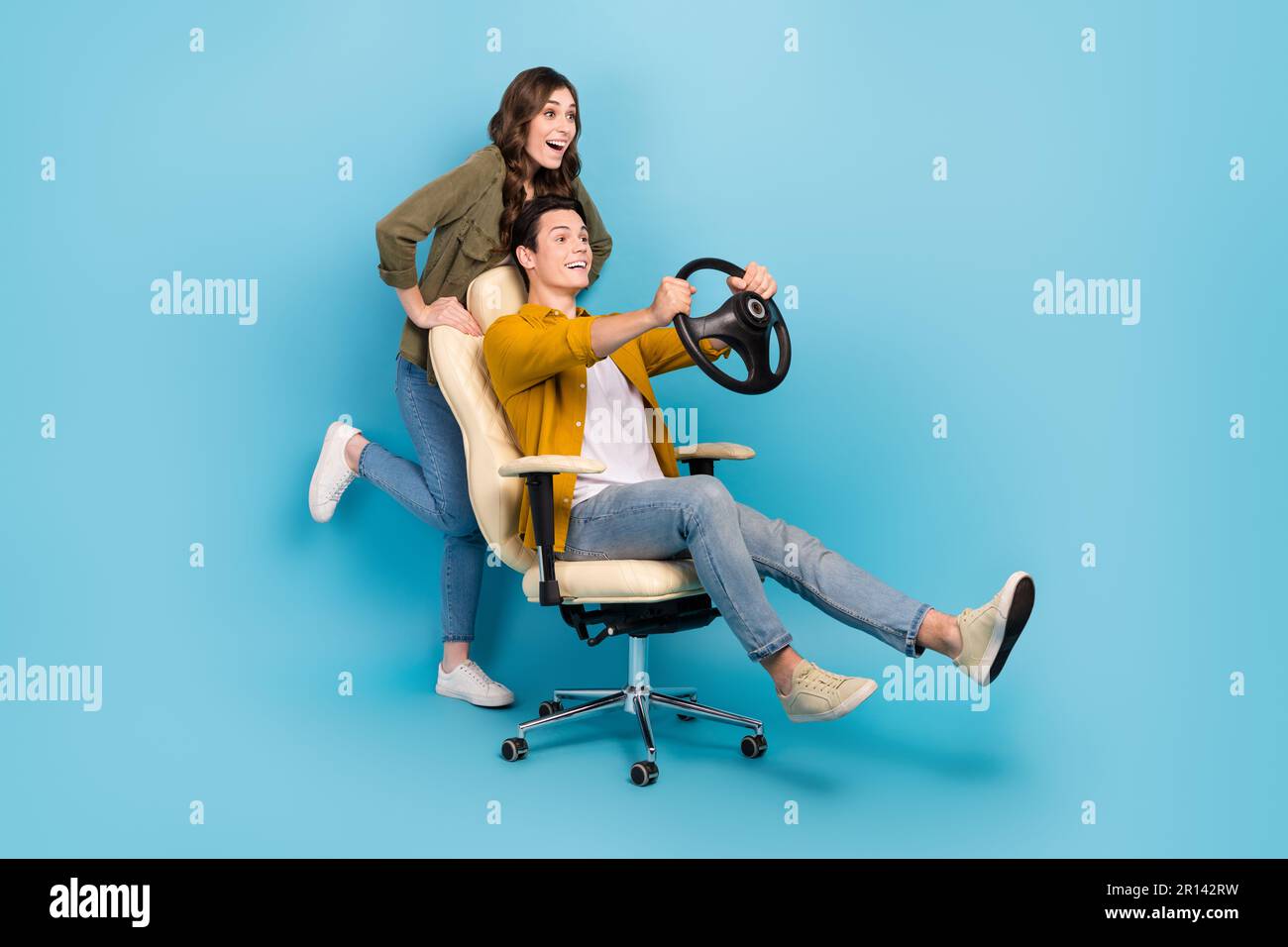 Full length photo of funny couple brother sister play push chair hold ...