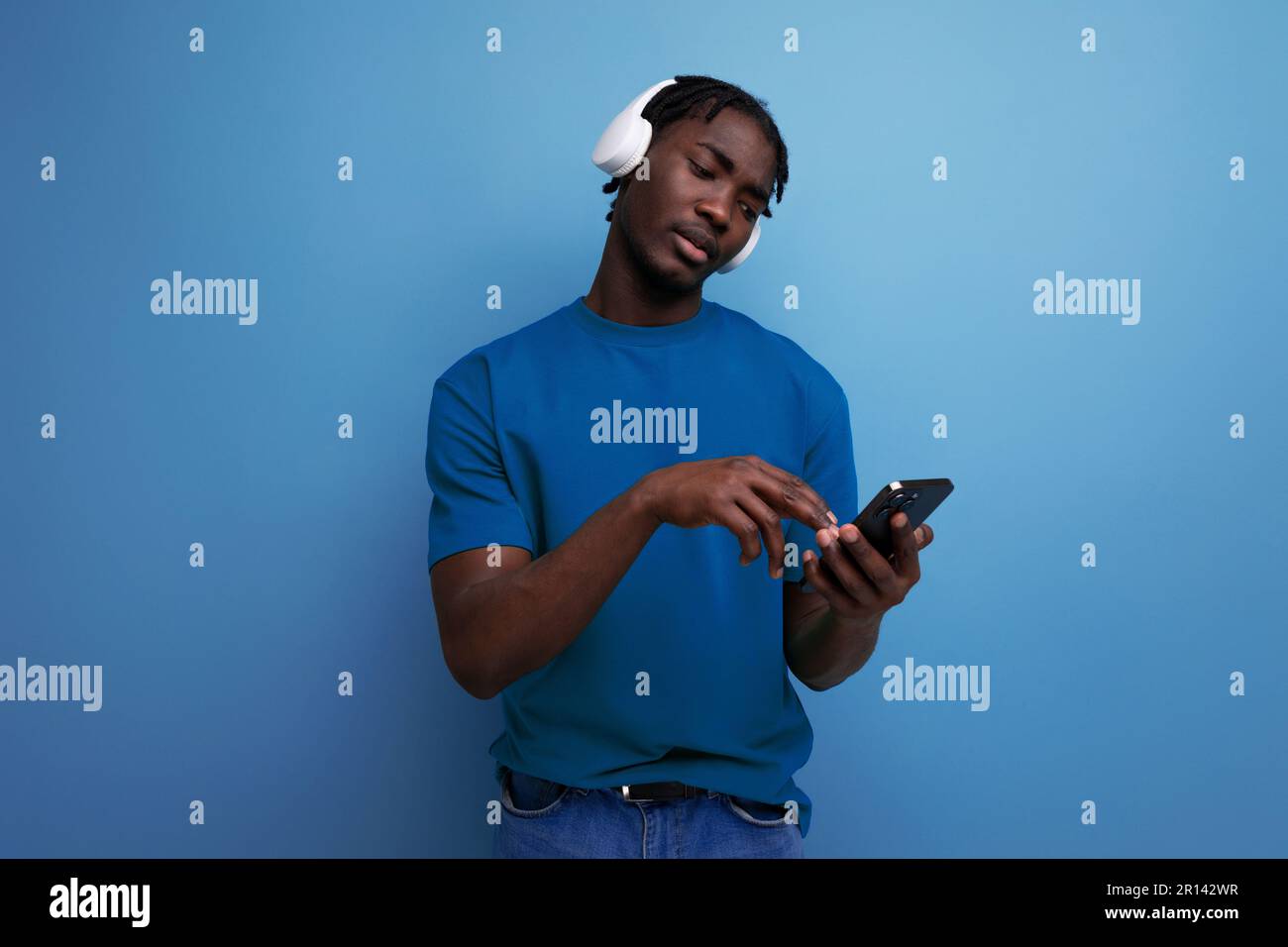 african gamer man with wireless headphones and powerful smartphone ...